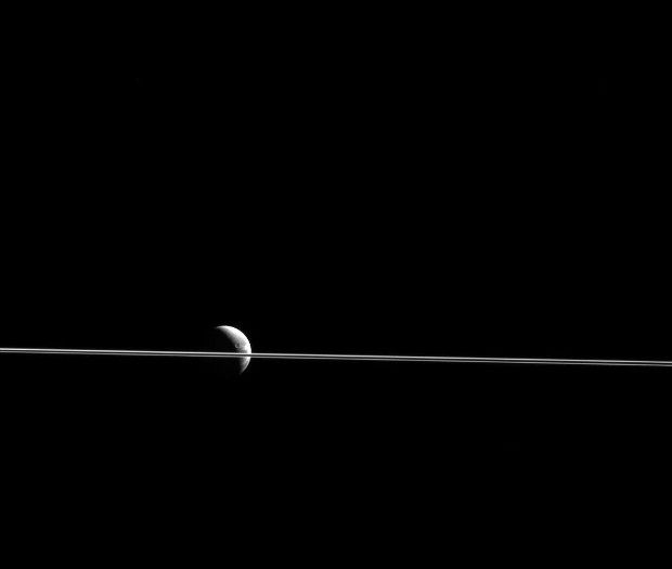 NASA Releases Stunning Photos of Saturn 'Cutting' Its Moon in Half ...